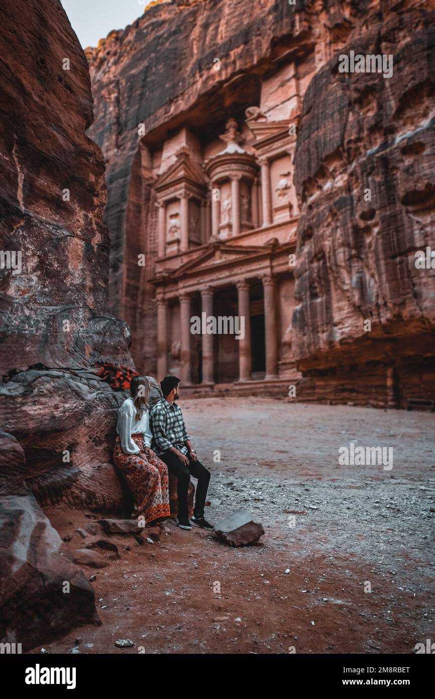 A couple outside the iconic Al Khazna treasury facade in Petra, Jordan ...