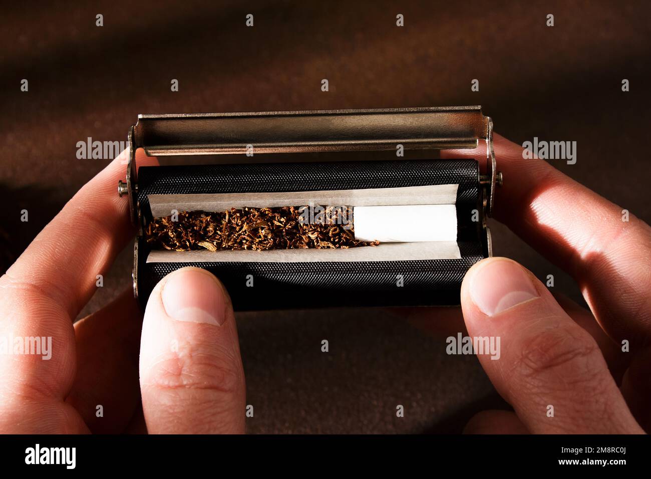 Hand rolling tobacco hi-res stock photography and images - Alamy