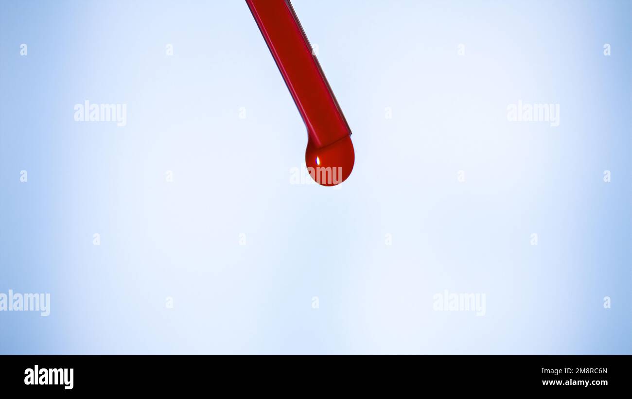 A drop of blood. Pipette. Dripping red liquid. A drop of red. Tests ...