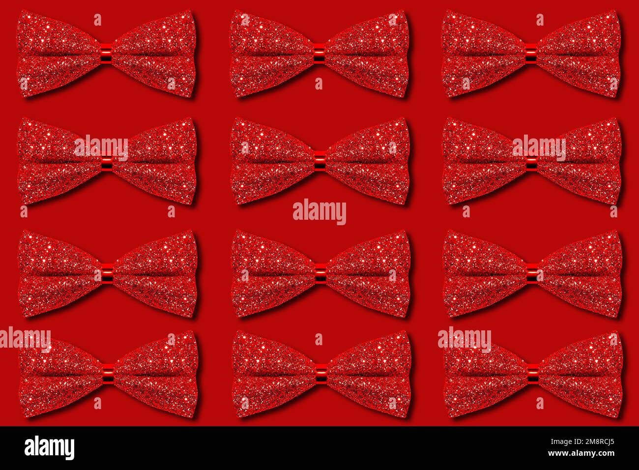 Lots of red shiny bows on a red background Stock Photo - Alamy