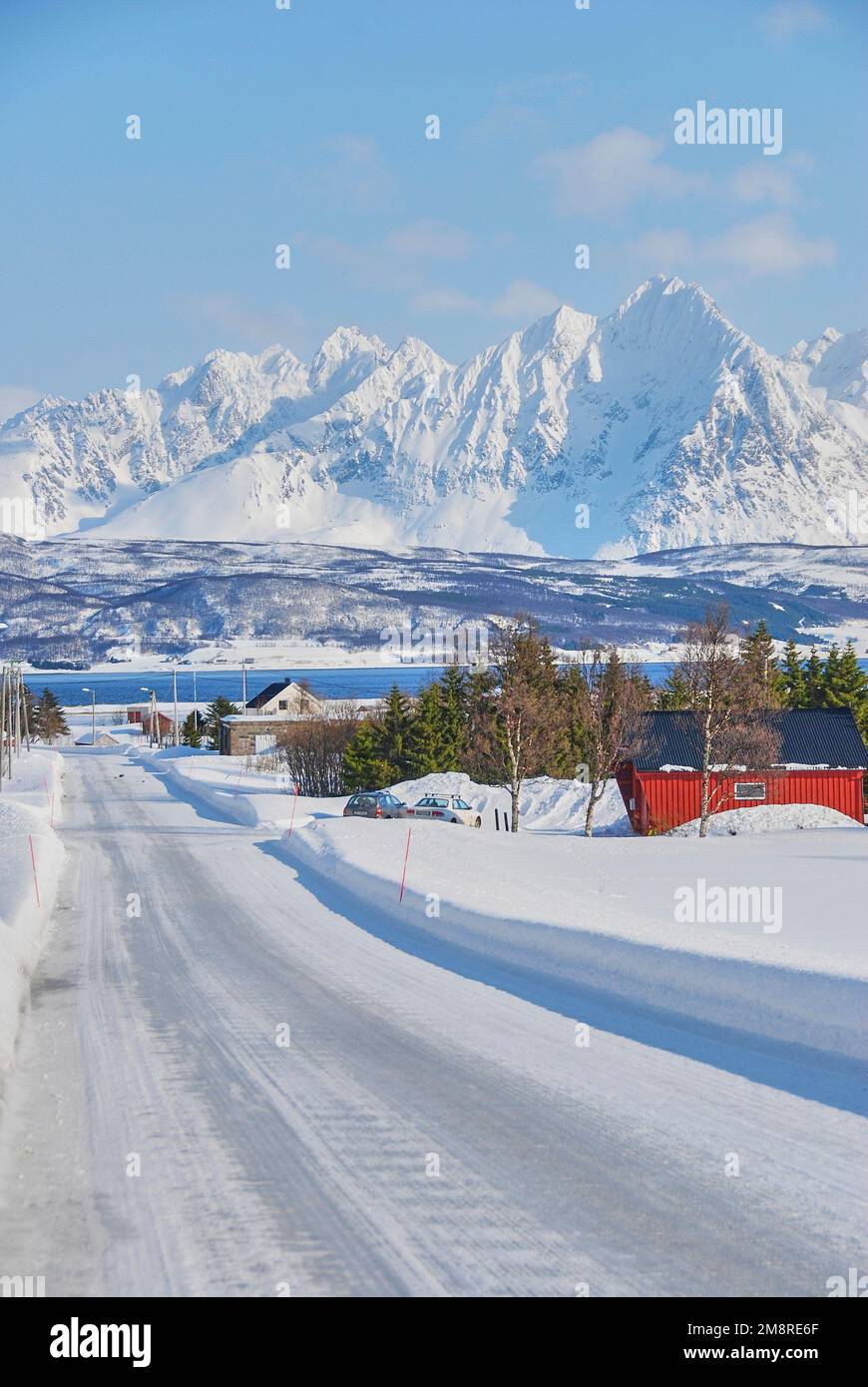 winter landscape with snow covered mountains and an icy road in the ...