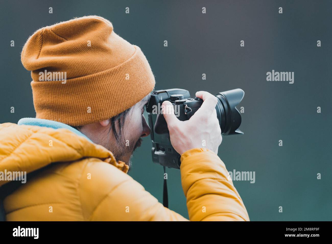 Selective focus of photographer taking landscape photos using digital ...