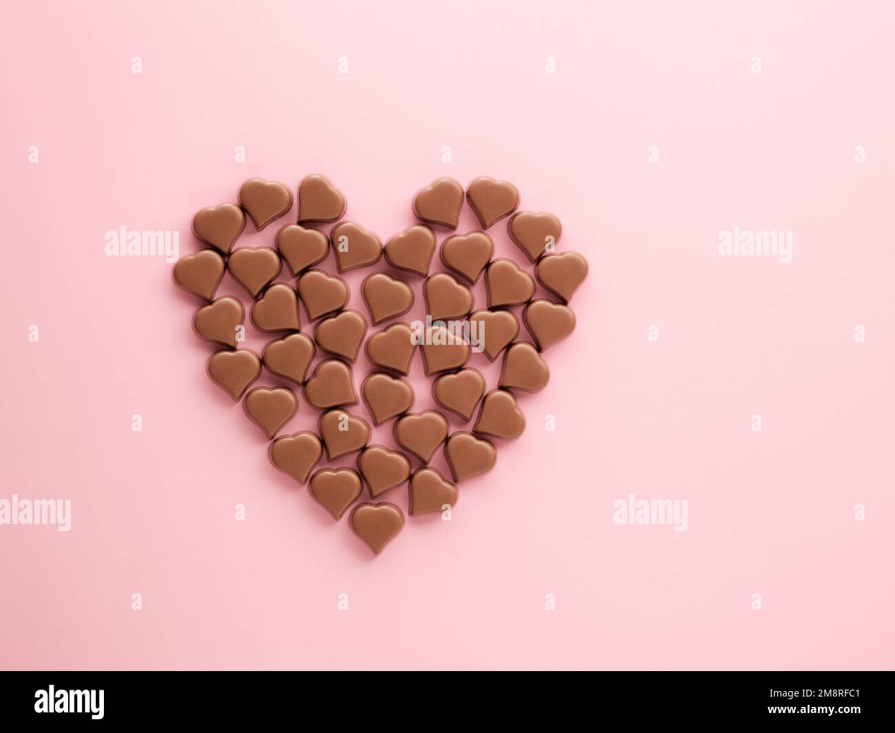 Big heart made of romantic chocolate confections in heart shapes on ...
