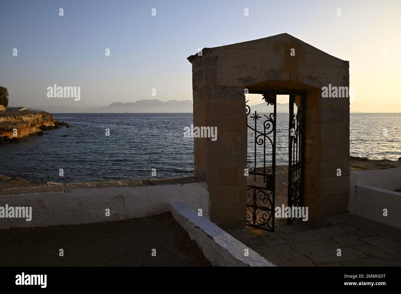 Scenic sunset view of the stone built main entrance gate of Aghioi ...