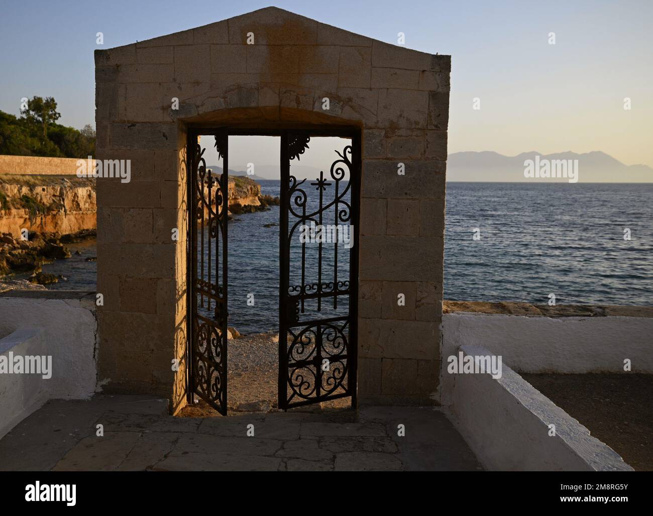Scenic sunset view of the stone built main entrance gate of Aghioi ...