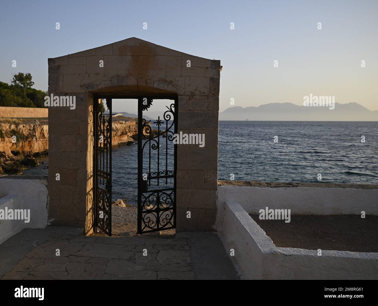 Scenic sunset view of the stone built main entrance gate of Aghioi ...