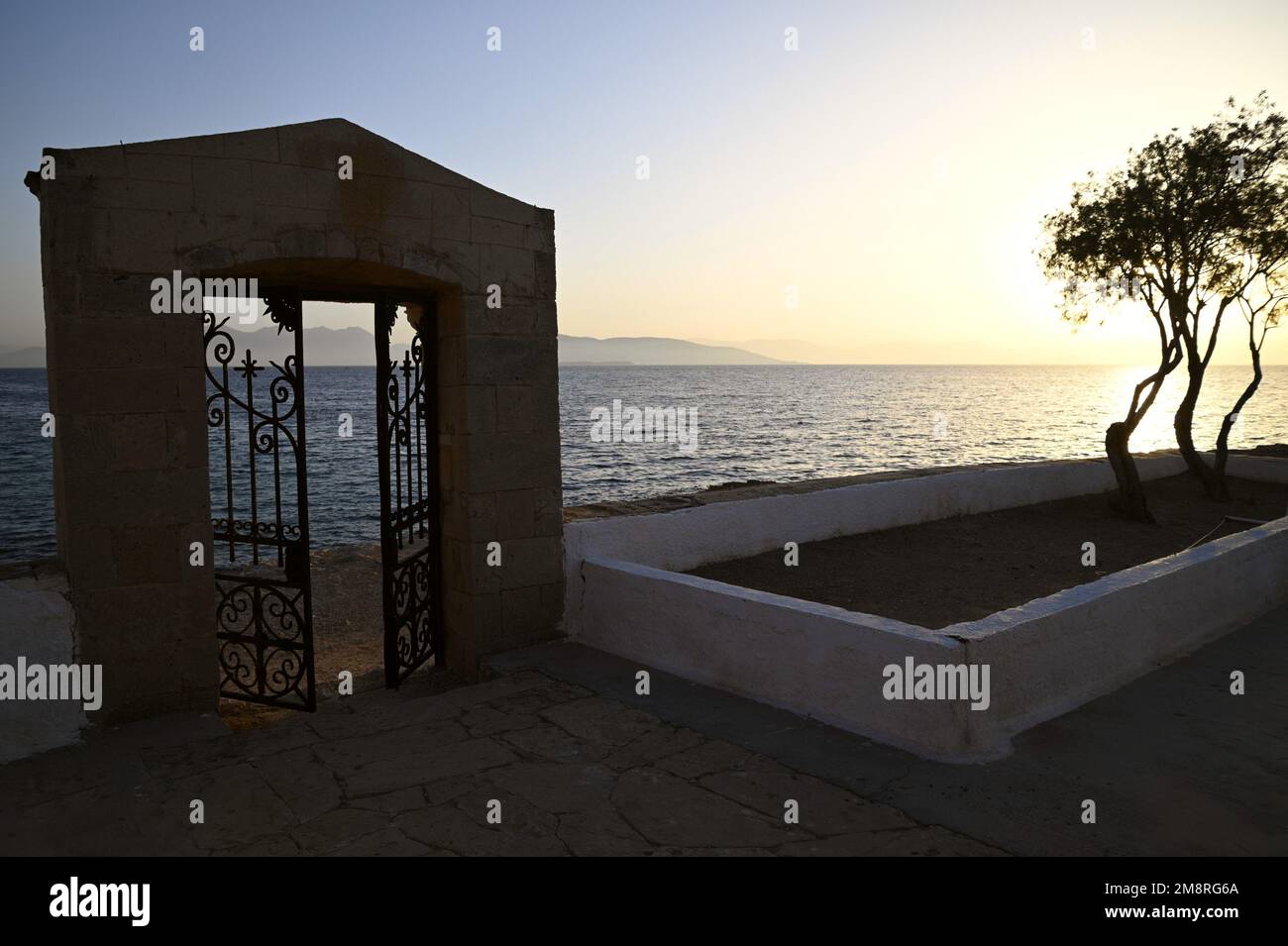 Scenic sunset view of the stone built main entrance gate of Aghioi ...
