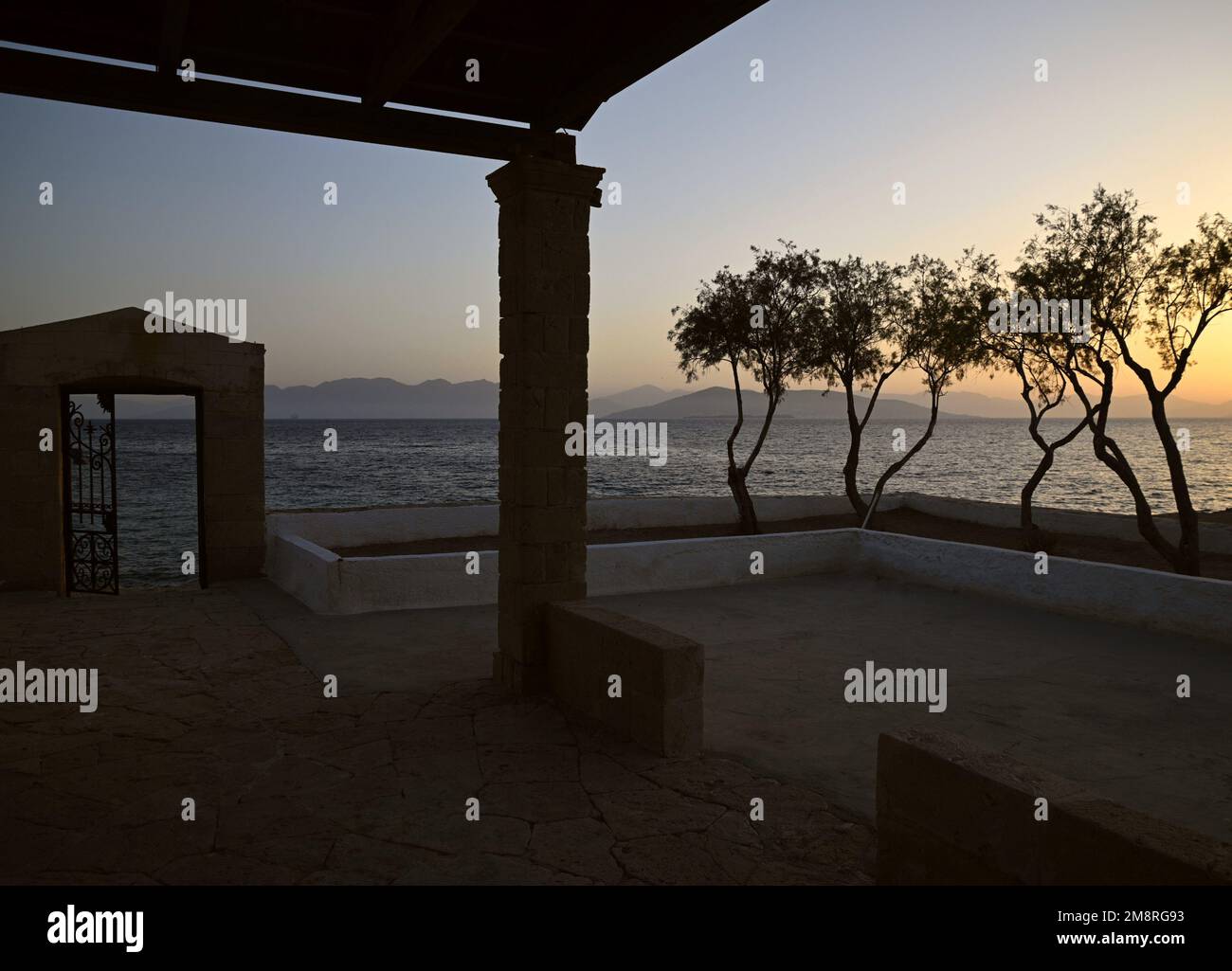 Scenic sunset view of the stone built main entrance gate of Aghioi ...