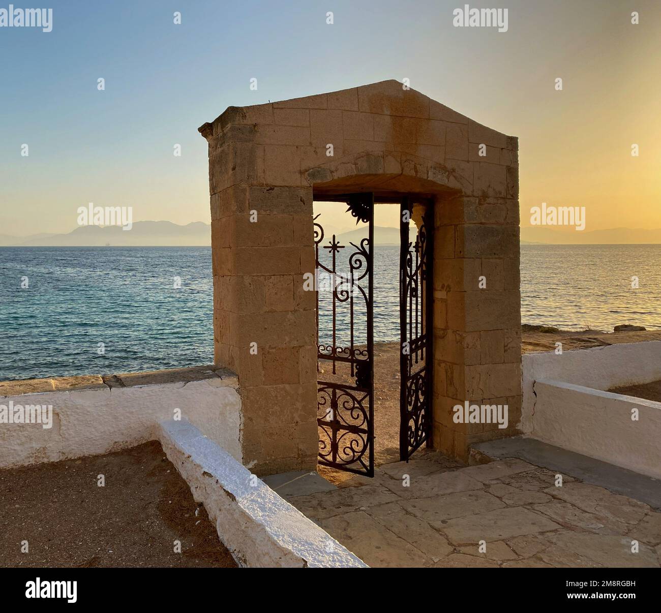 Scenic sunset view of the stone built main entrance gate of Aghioi ...