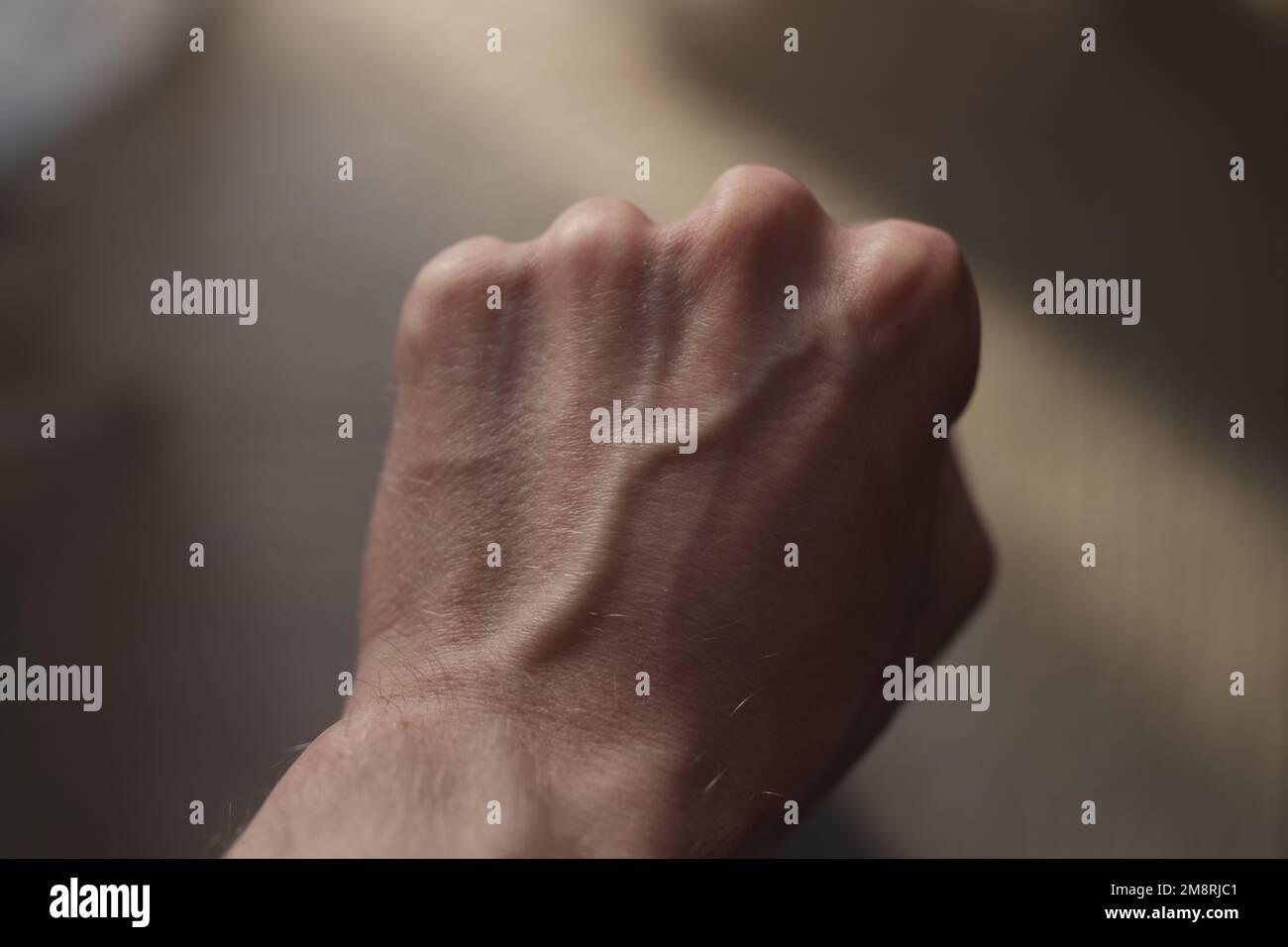 Closeup photo of yopung man hand with visible veins in contrast ...