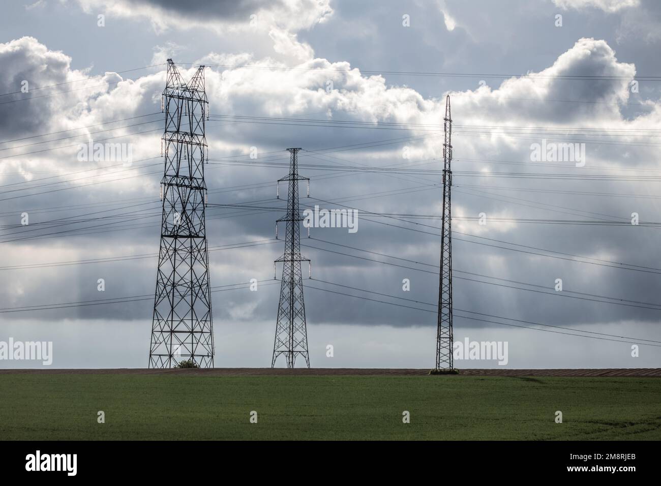 Three transmission towers in the open field Stock Photo - Alamy