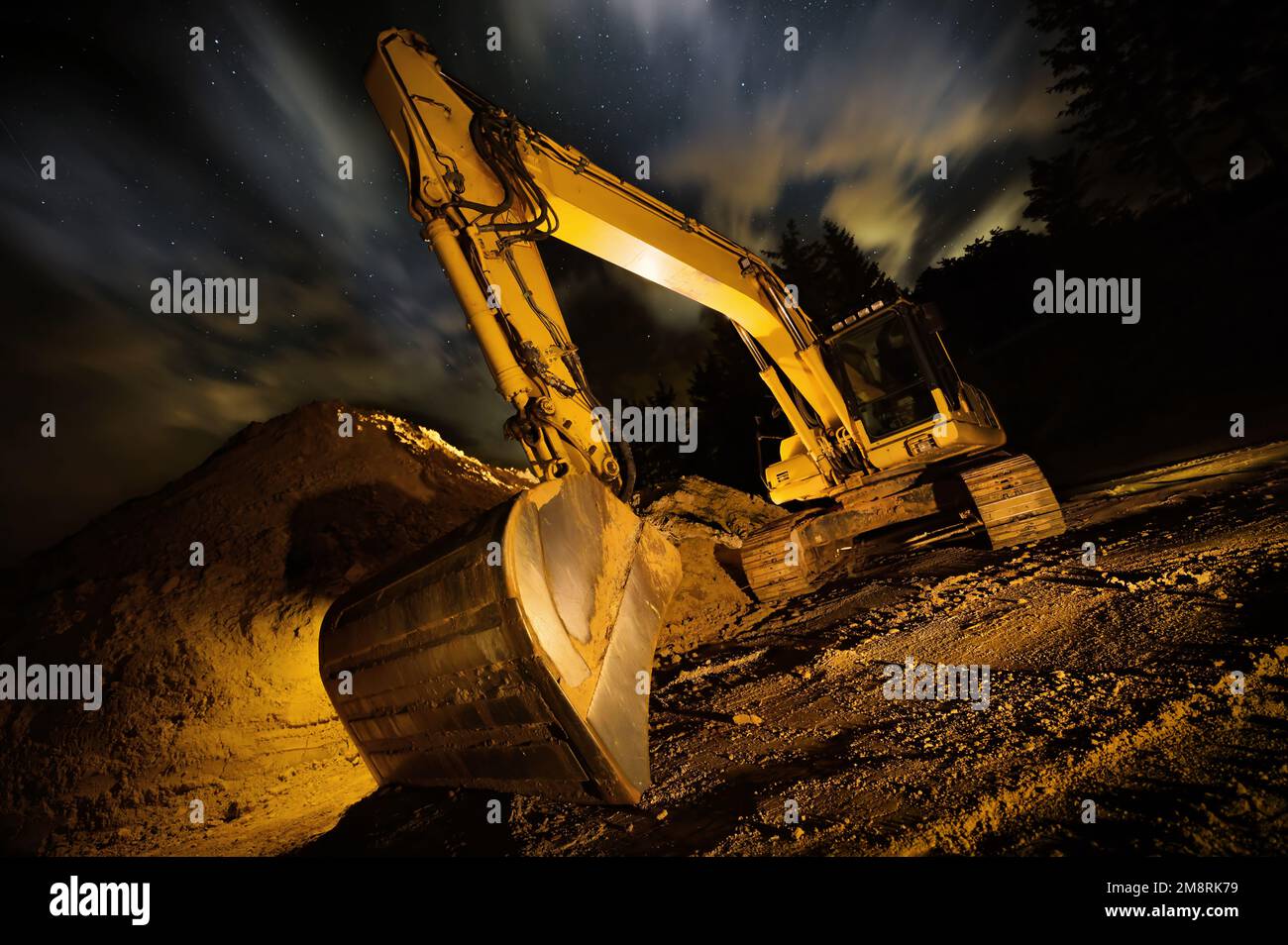 Excavator at night, dramatic lighting and composition, with clouds and ...