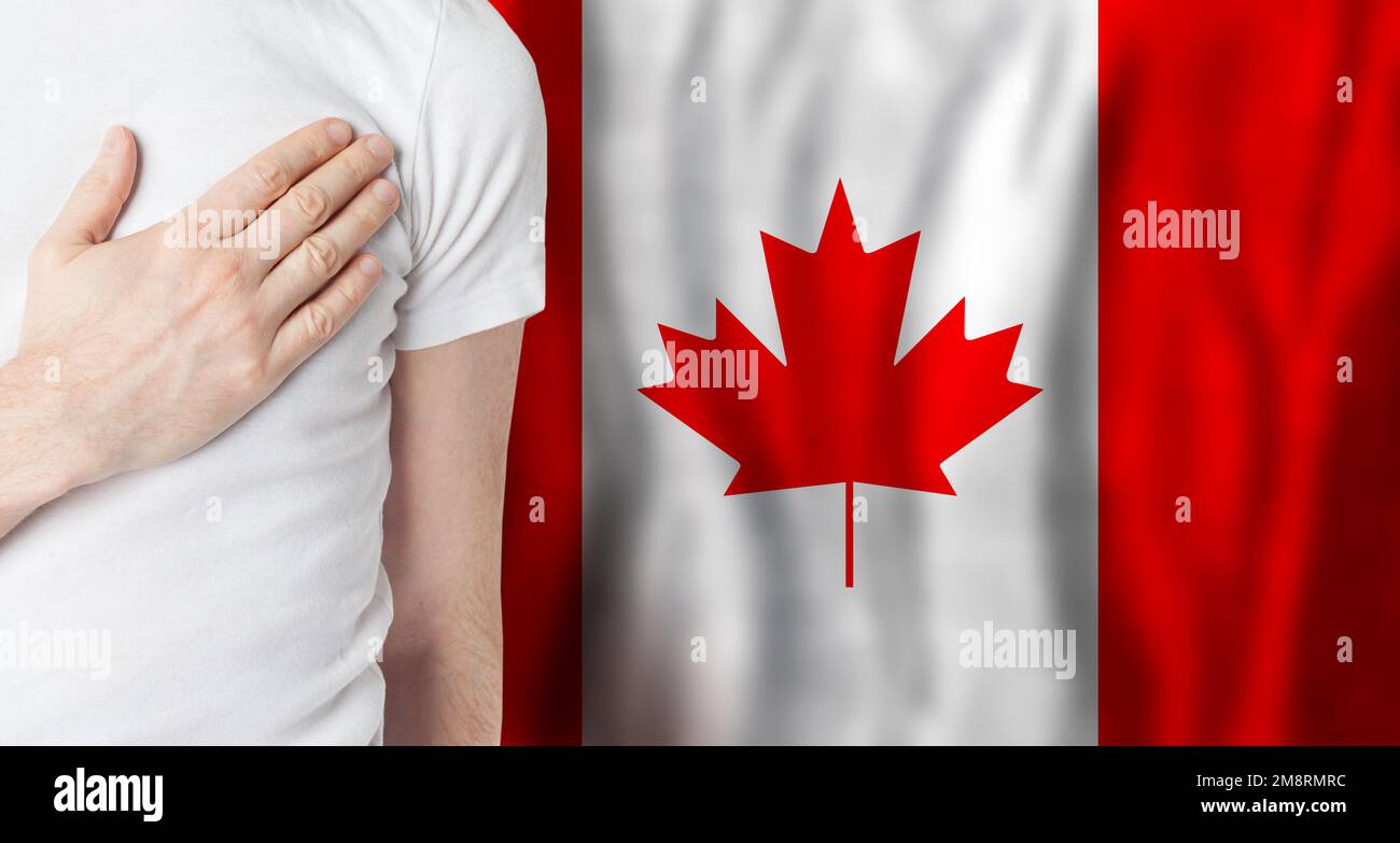 Canadian person with hand on heart on the background of Canada flag ...