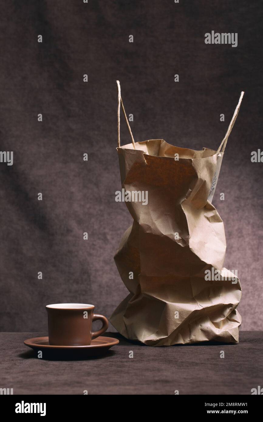 Still life with a paper bag and a coffee cup Stock Photo - Alamy