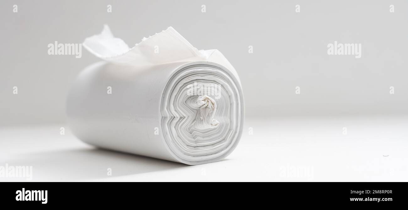 White plastic polyethylene trash bag roll isolated over the white ...