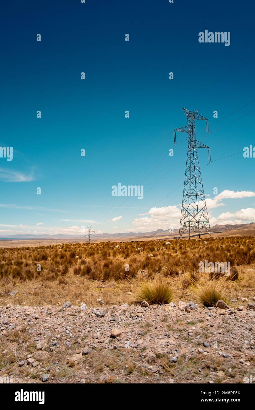 A vertical shot of a high voltage tower in the valley of the Peruvian ...