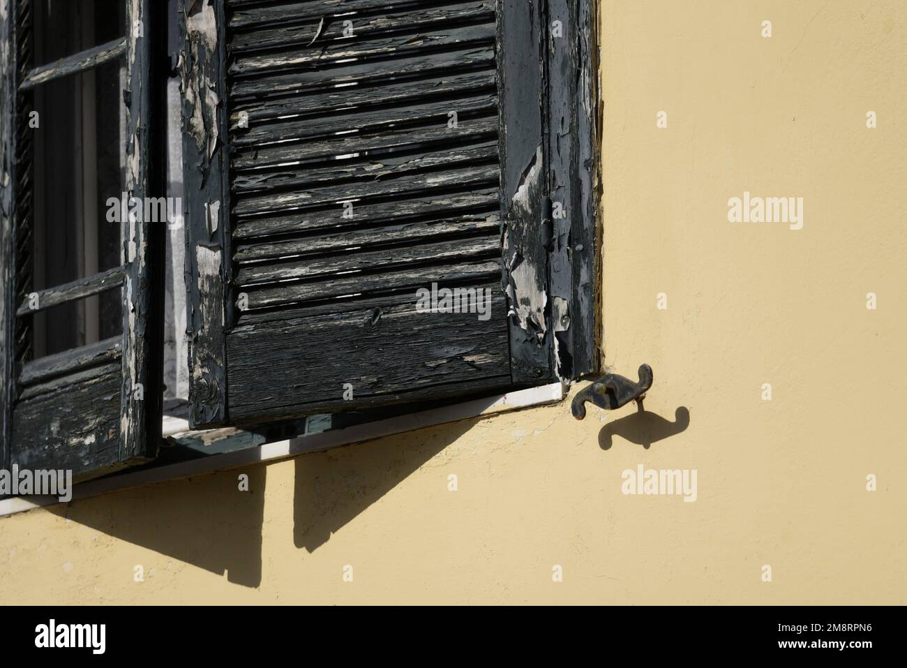 Antique wooden window shutters on an ochre stucco wall Stock Photo - Alamy