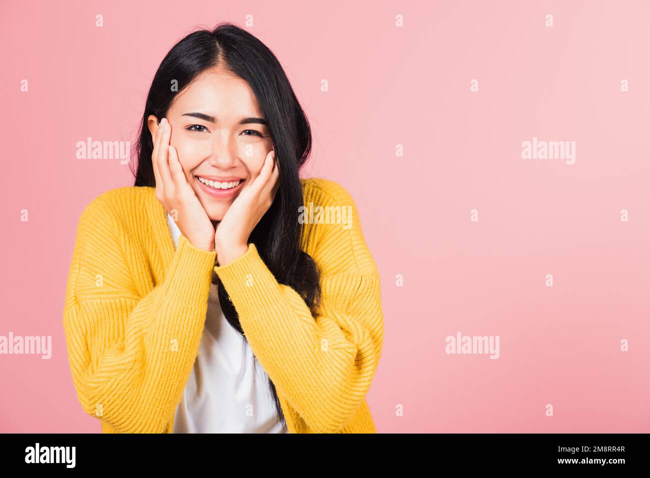 woman smile holding her cheeks Stock Photo - Alamy