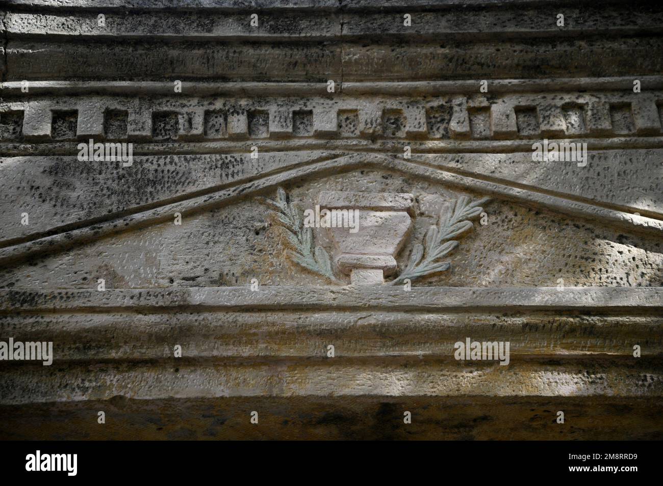 Ancient hand carved stone pediment with laurel symbols Stock Photo - Alamy