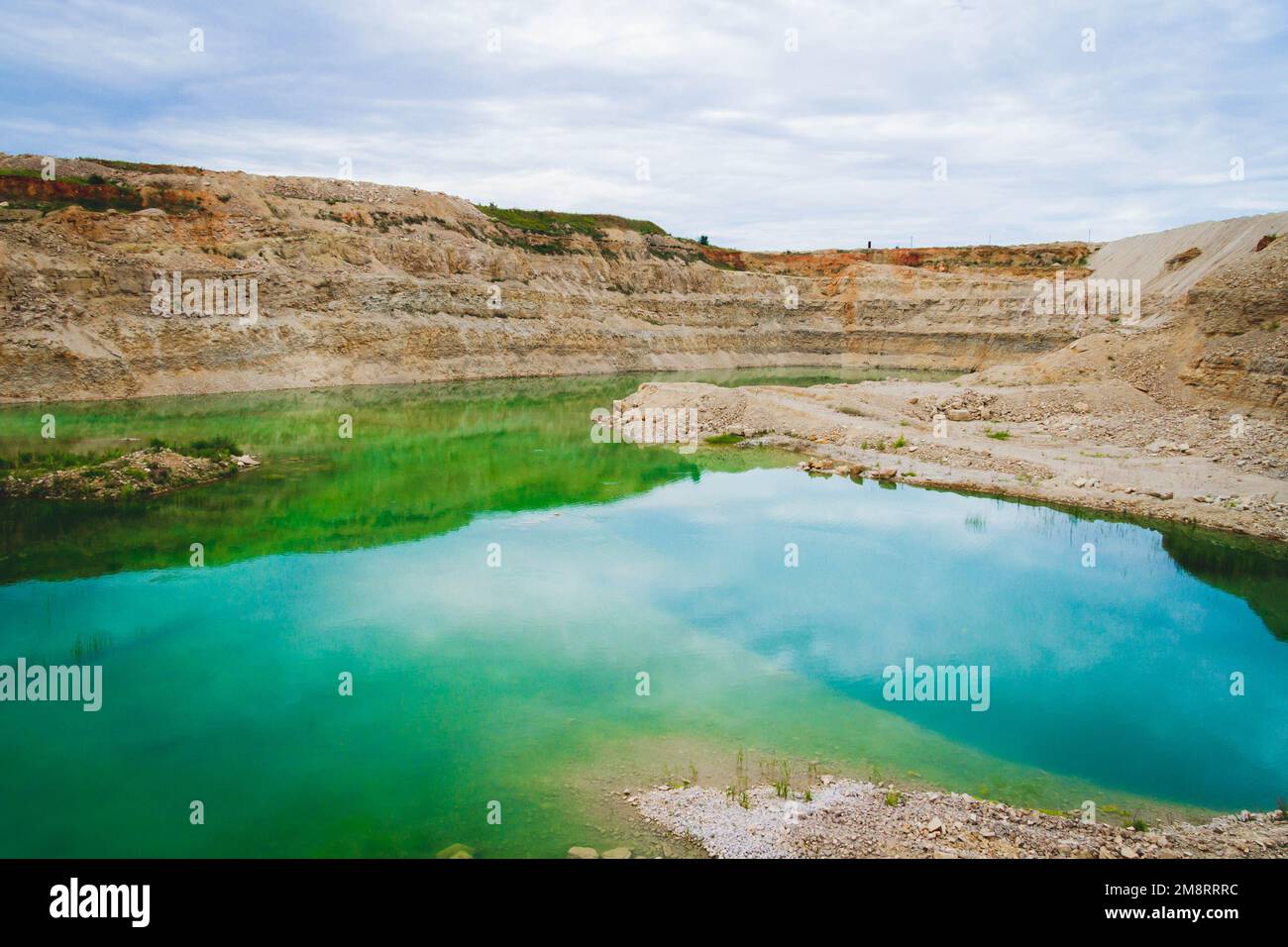 Lake formation in an old abandoned quarry. Quarry lake. Crushed stone ...