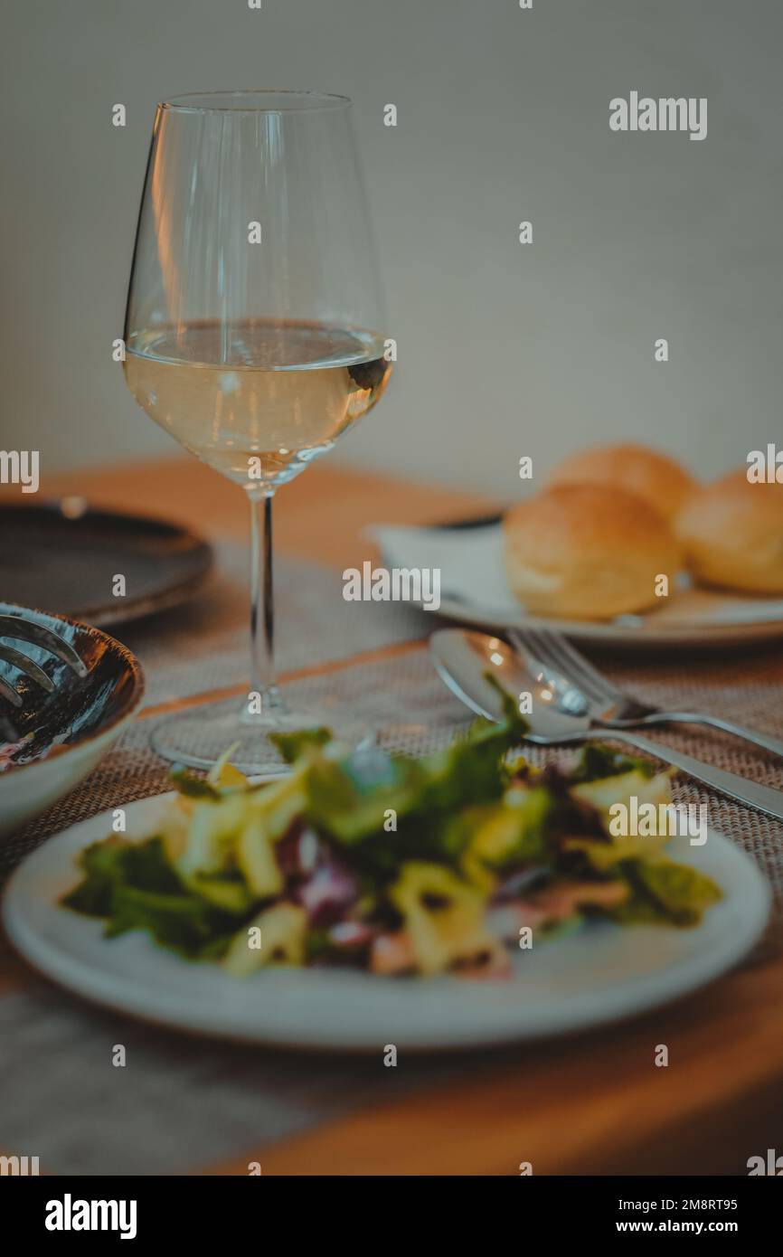 Italian restaurant table with dinner of pasta salad and a glass of wine ...