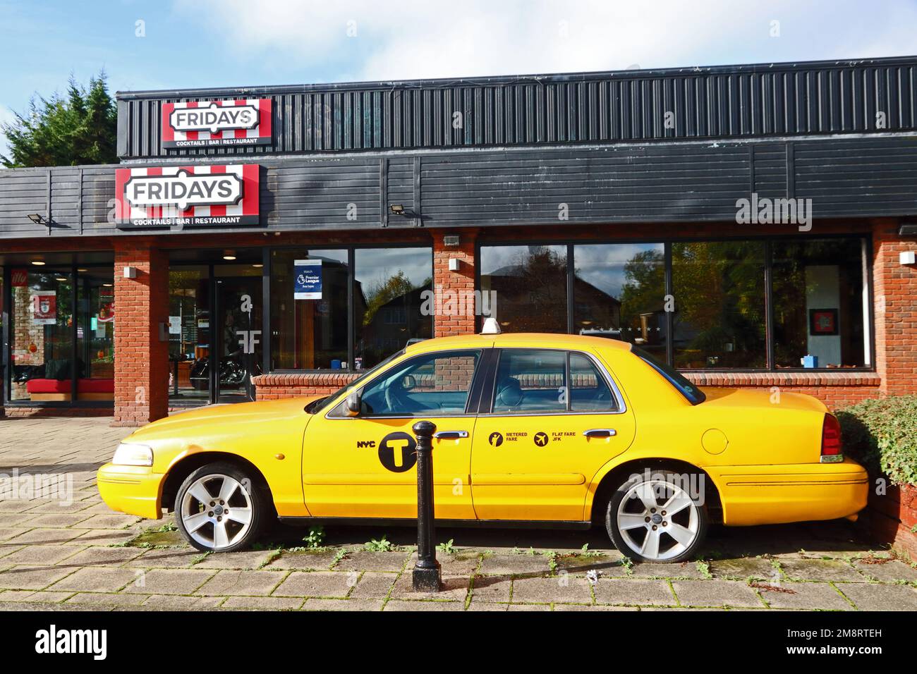 Yellow former New York taxi cab outside T G I Fridays restaurant ...