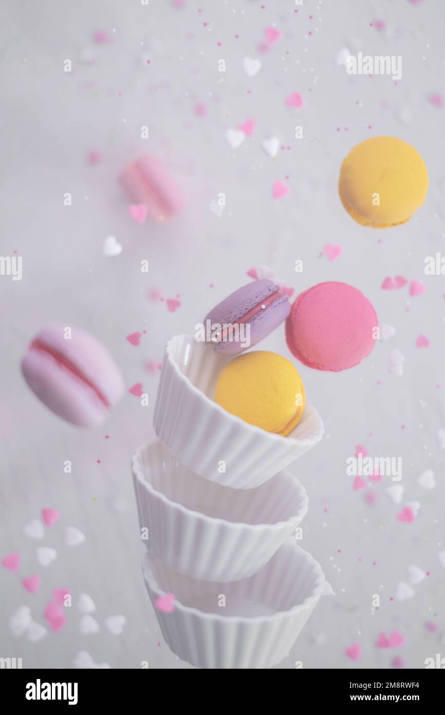 pastel pink colors macaroons levitating with hearts decor Stock Photo ...