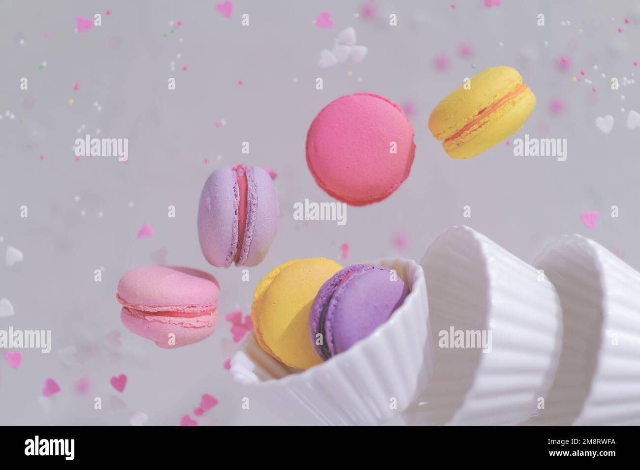 pastel pink colors macaroons levitating with hearts decor Stock Photo ...