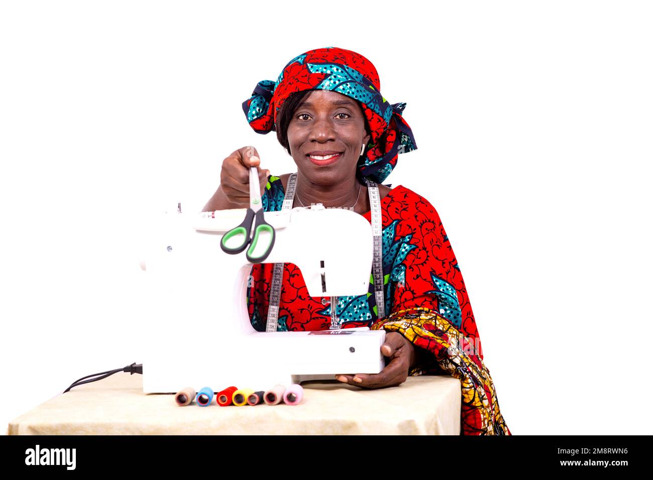Beautiful female dressmaker sitting in hi-res stock photography and ...