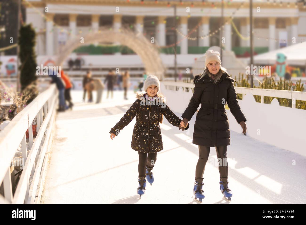 beautiful happy mother and daughter smiling at camera while standing ...