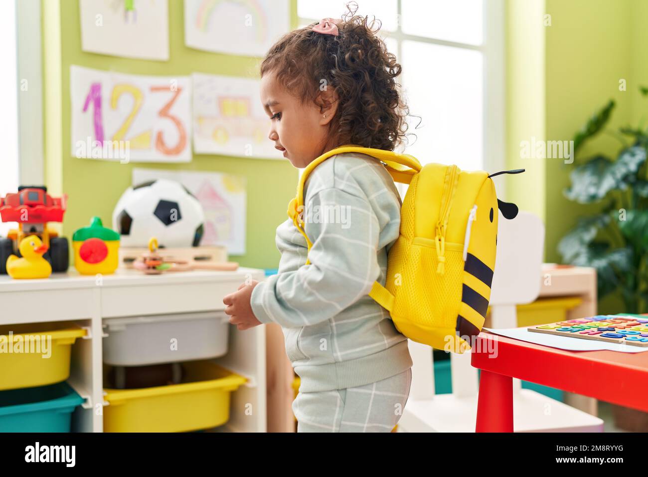 Adorable hispanic girl student wearing backpack standing at ...