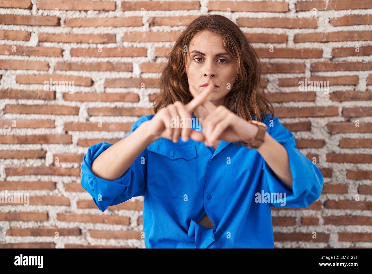 Beautiful Brunette Woman Standing Over Bricks Wall Rejection Expression