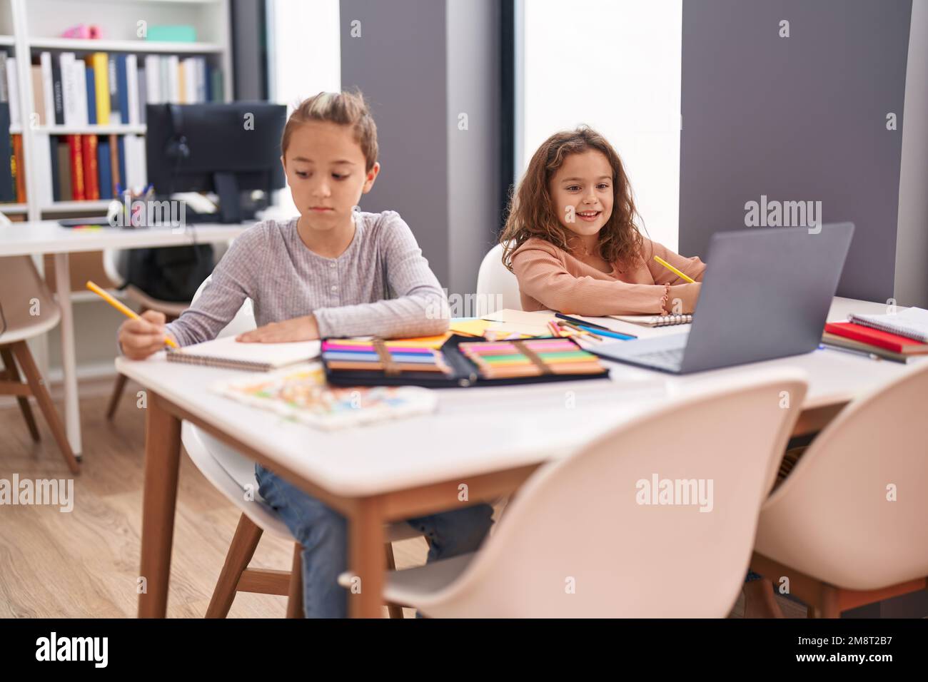 Two kids students using computer studying at classroom Stock Photo - Alamy