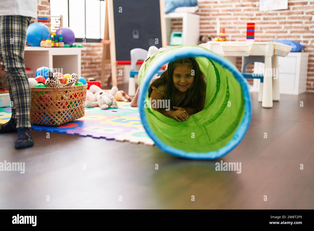Child crawling through play tunnel hi-res stock photography and images ...