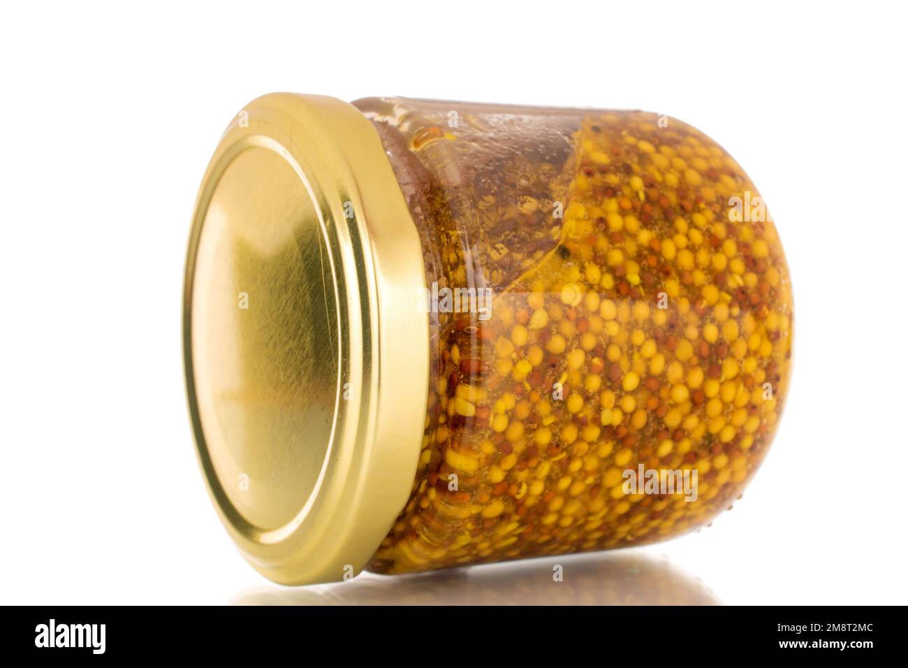 French mustard in a glass jar, macro, isolated on white background ...