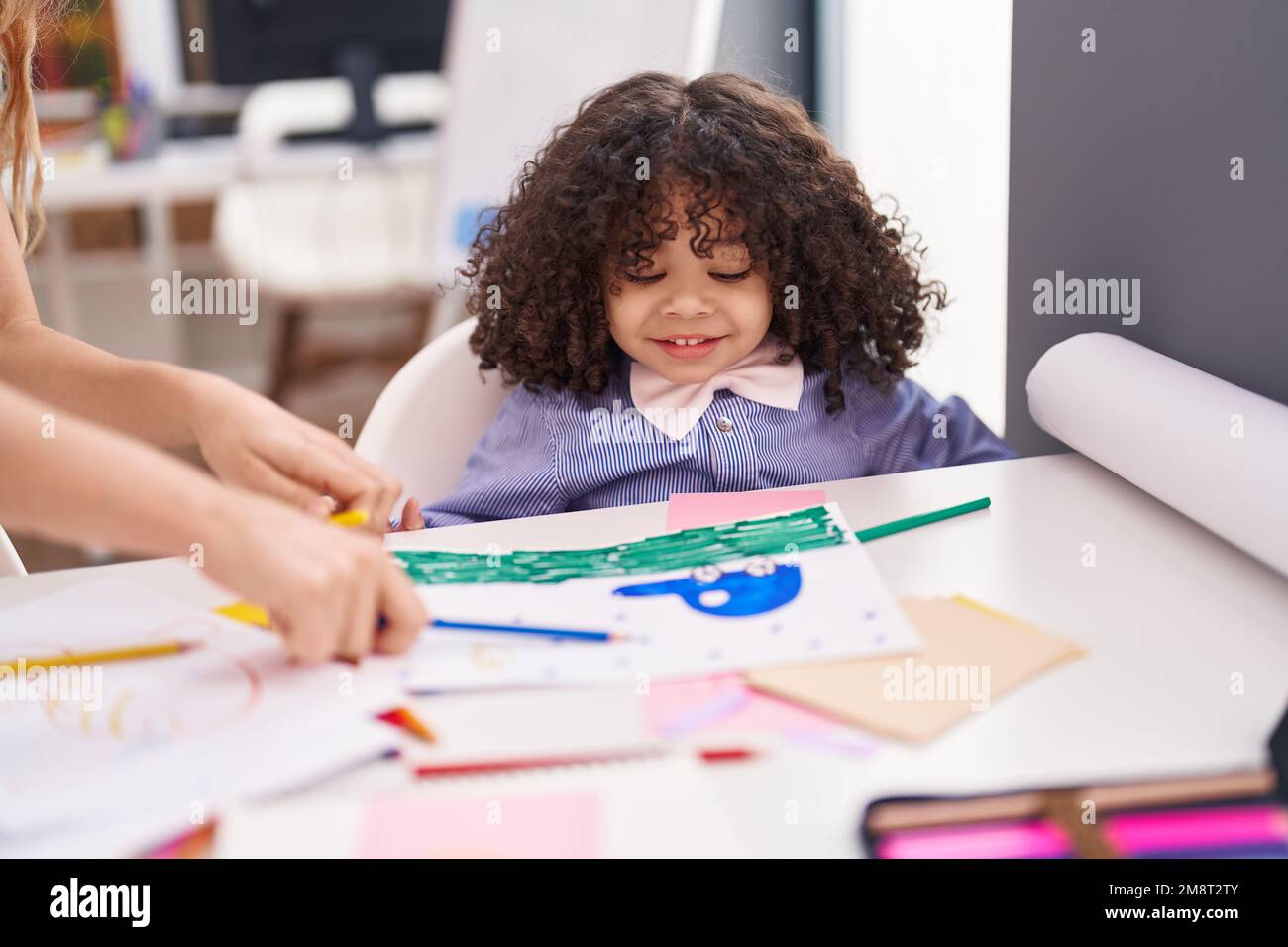 African american toddler preschool student sitting on table looking ...