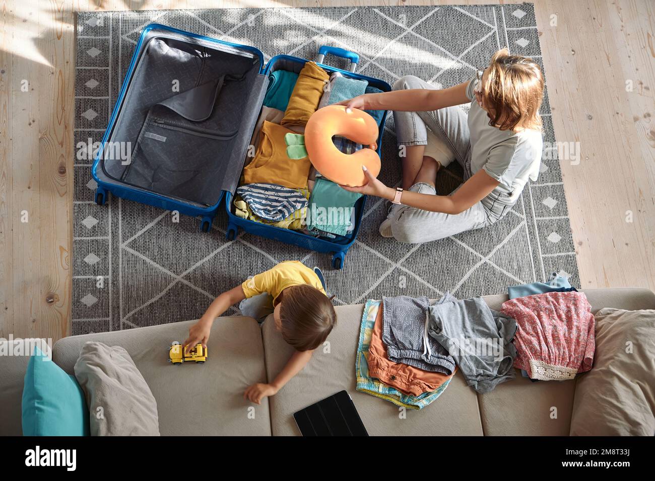 Family going on a trip or vacation, mother packing a suitcase and ...