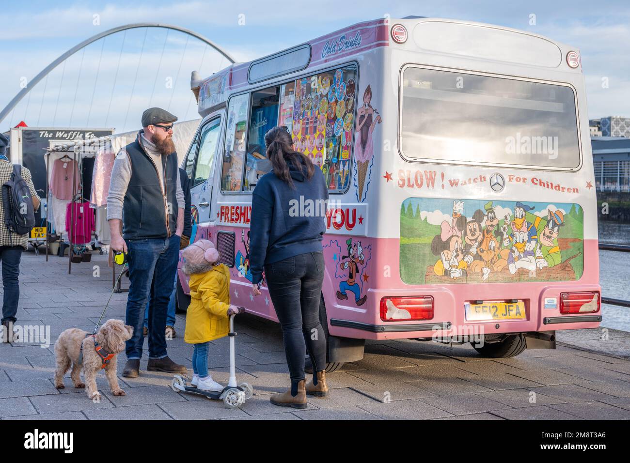 A family group consider buying ice cream from a van at the Sunday ...