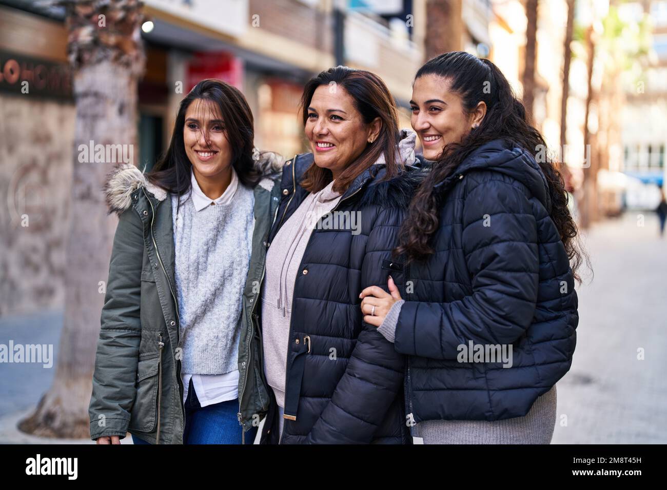 Three woman mother and daughters standing together at street Stock ...