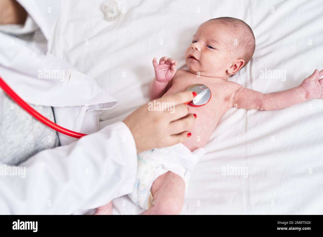 Adorable caucasian baby having heart examination with stethoscope at ...