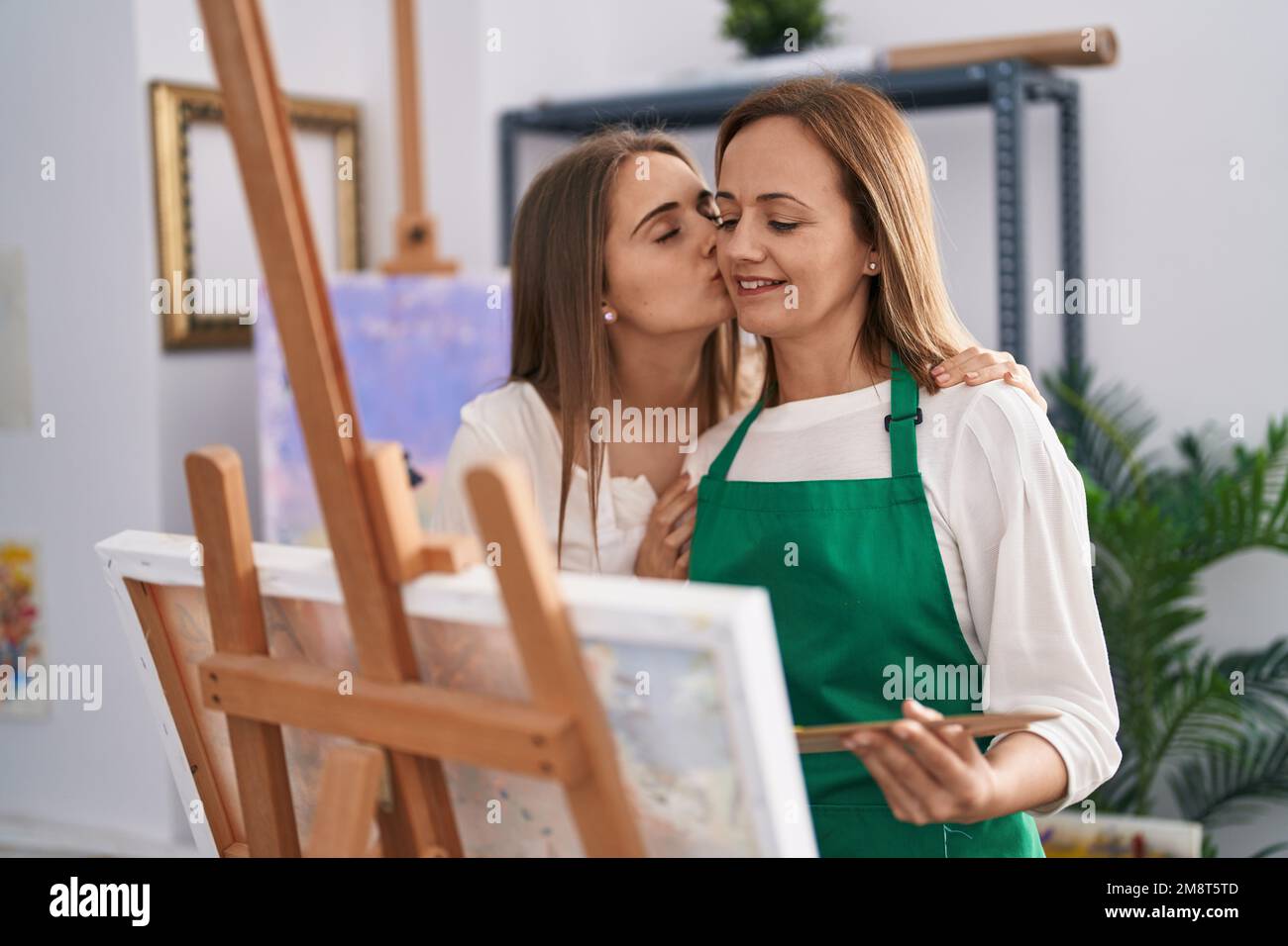 Two women artists drawing and kissing at art studio Stock Photo - Alamy