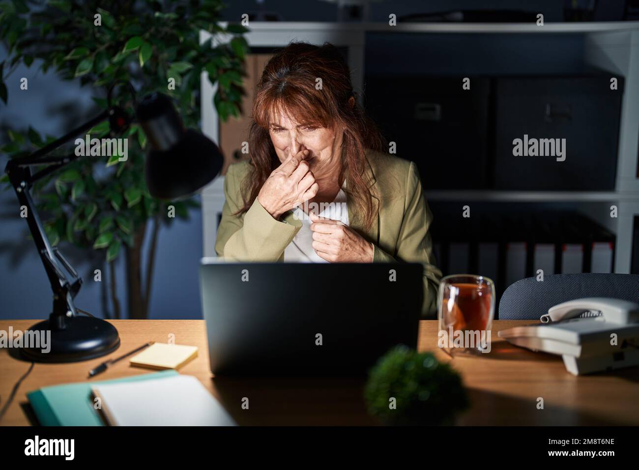 Middle age hispanic woman working using computer laptop at night ...