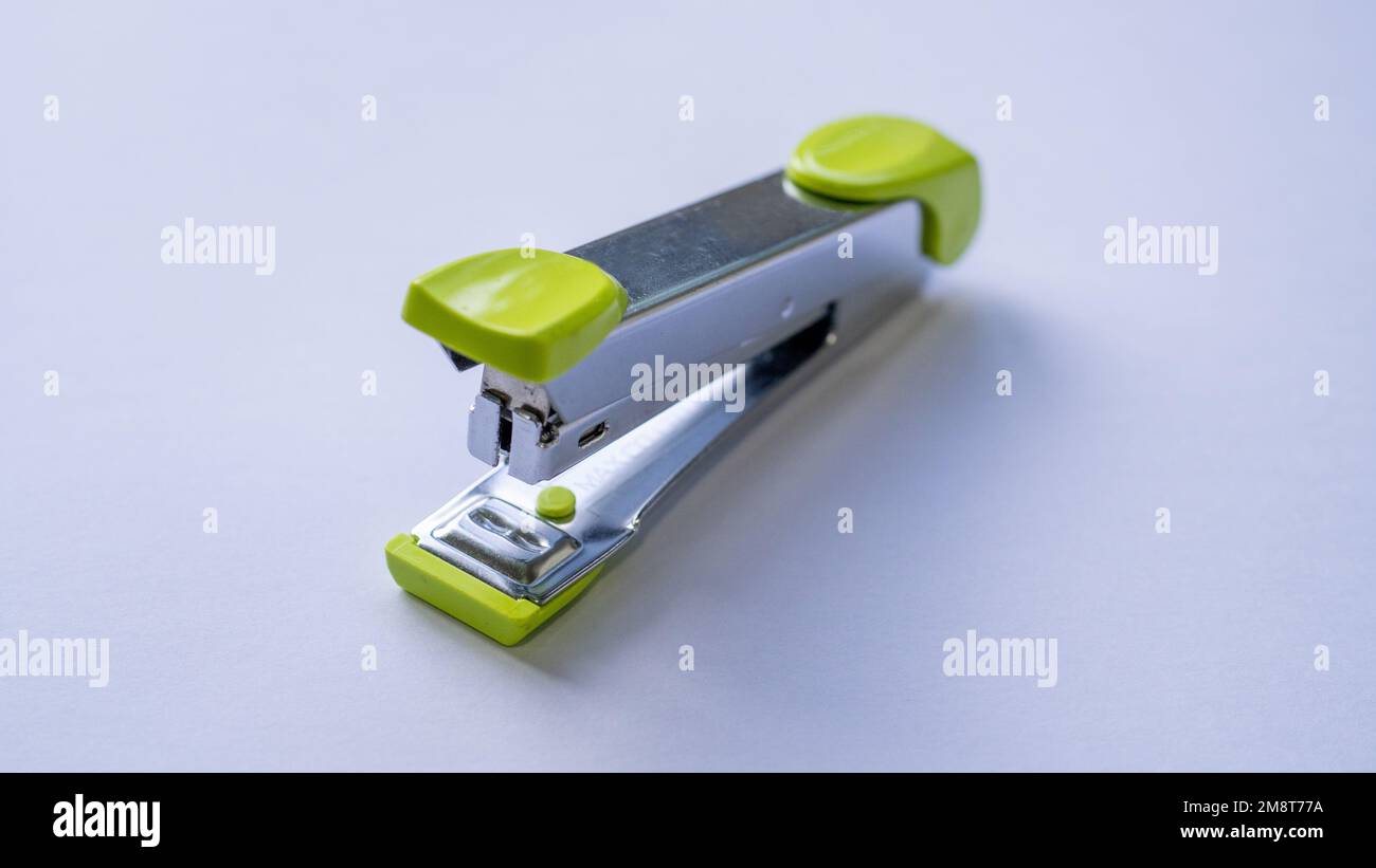 Green stapler on a white background Stock Photo - Alamy