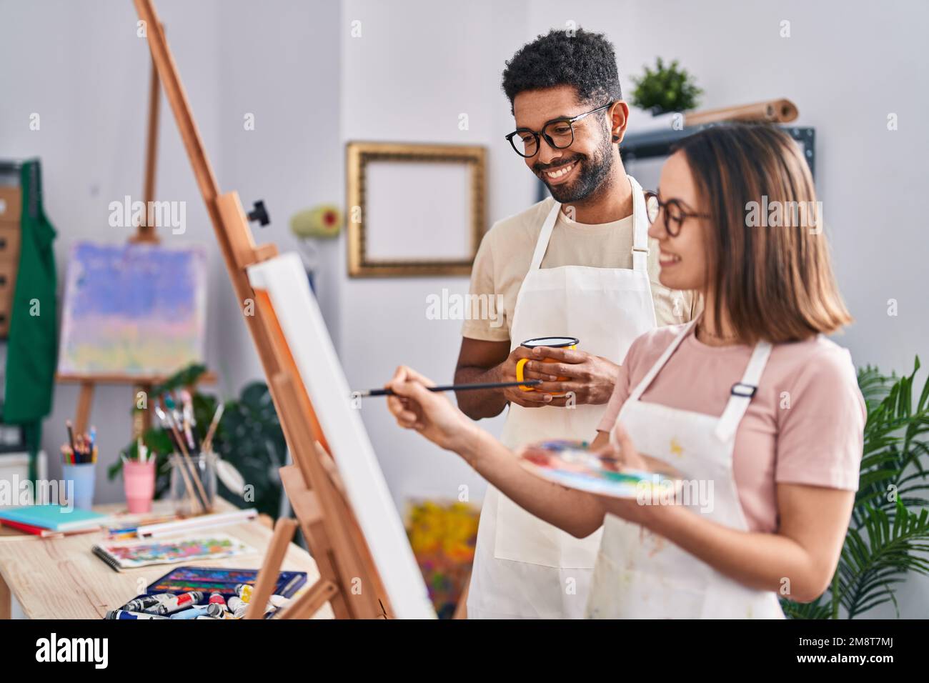 Man and woman artists drinking coffee drawing at art studio Stock Photo ...