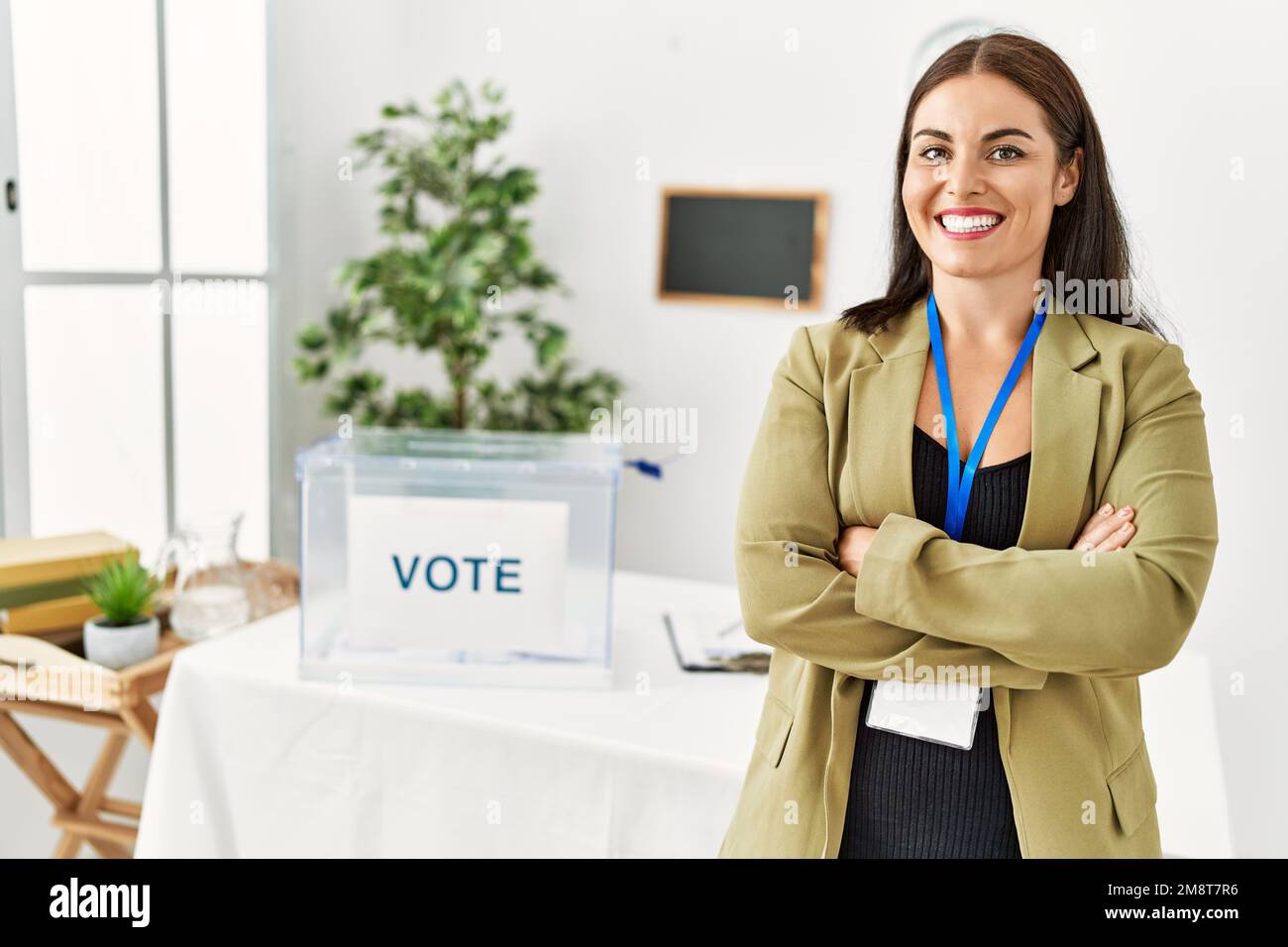 Young beautiful hispanic woman electoral table president standing with ...