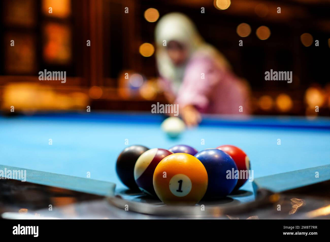 Hijab women play billiards with ball position 1 in front of the hole ...