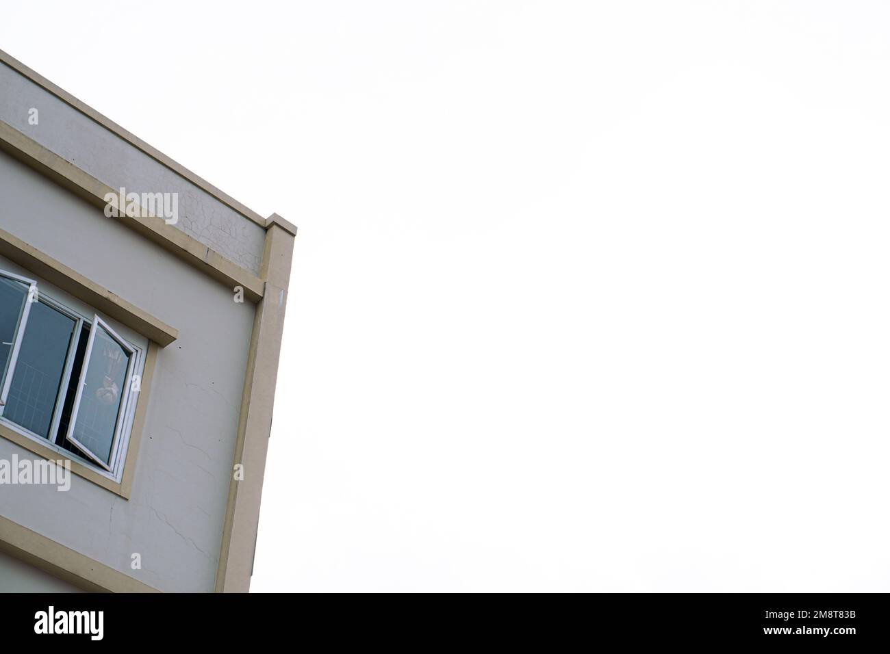 Top corner of plain house building and shop windows with copy space ...