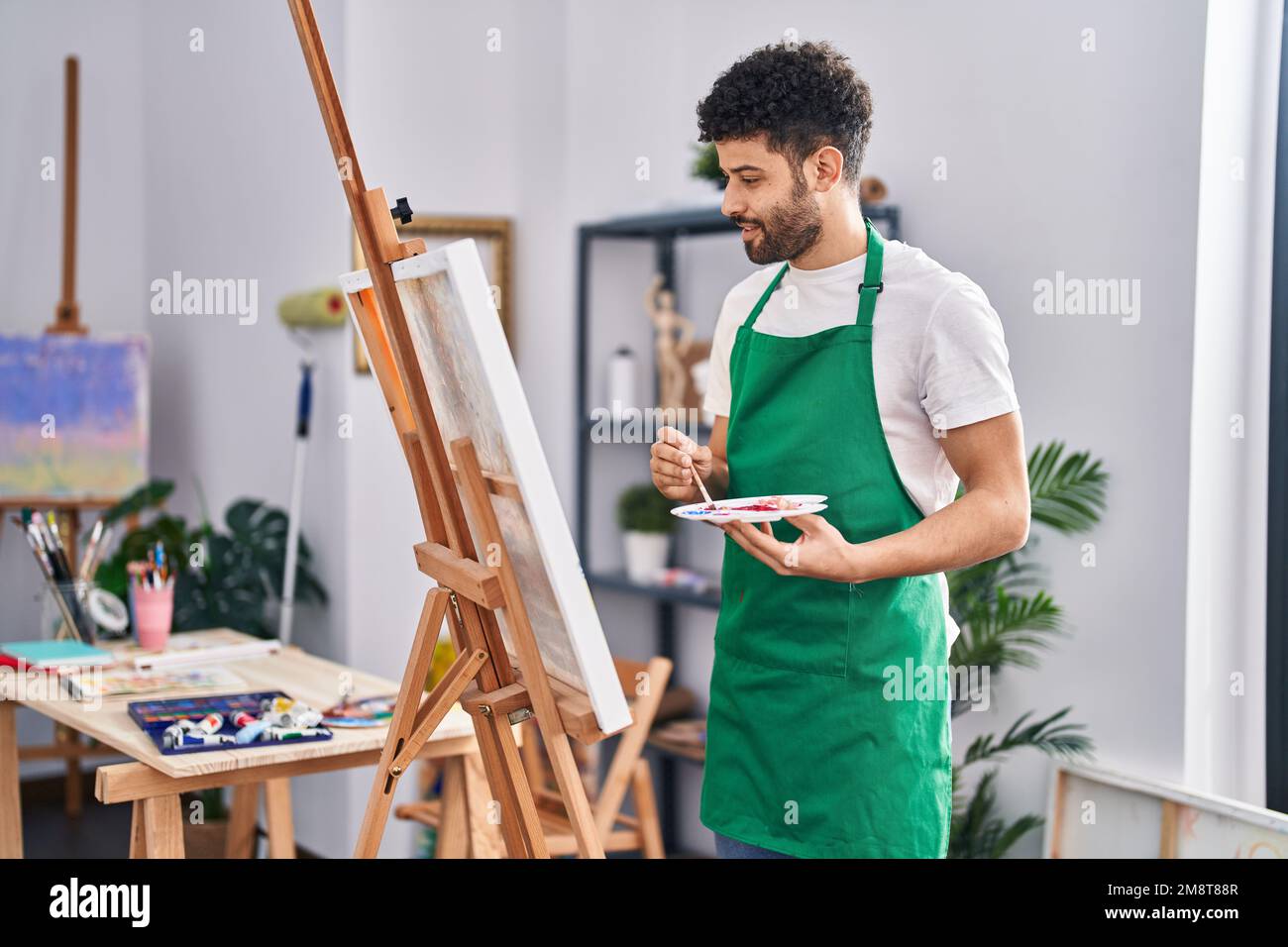 Young arab man artist smiling confident drawing at art studio Stock ...
