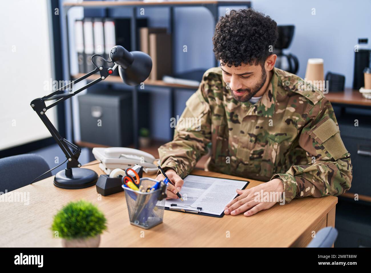 Young arab man army soldier signing contract at office Stock Photo - Alamy