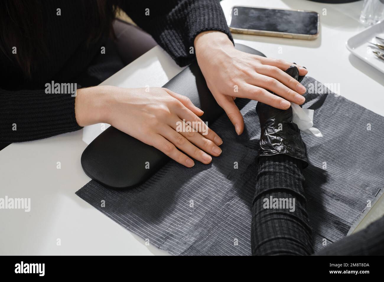 Nail service. Cropped view of the girl getting nails done at beauty ...
